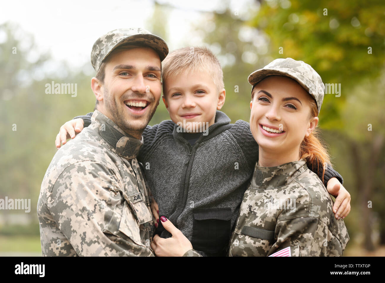Military family reunited on a sunny day Stock Photo - Alamy