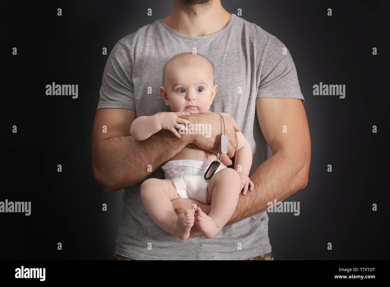 Military father holding his newborn baby Stock Photo - Alamy