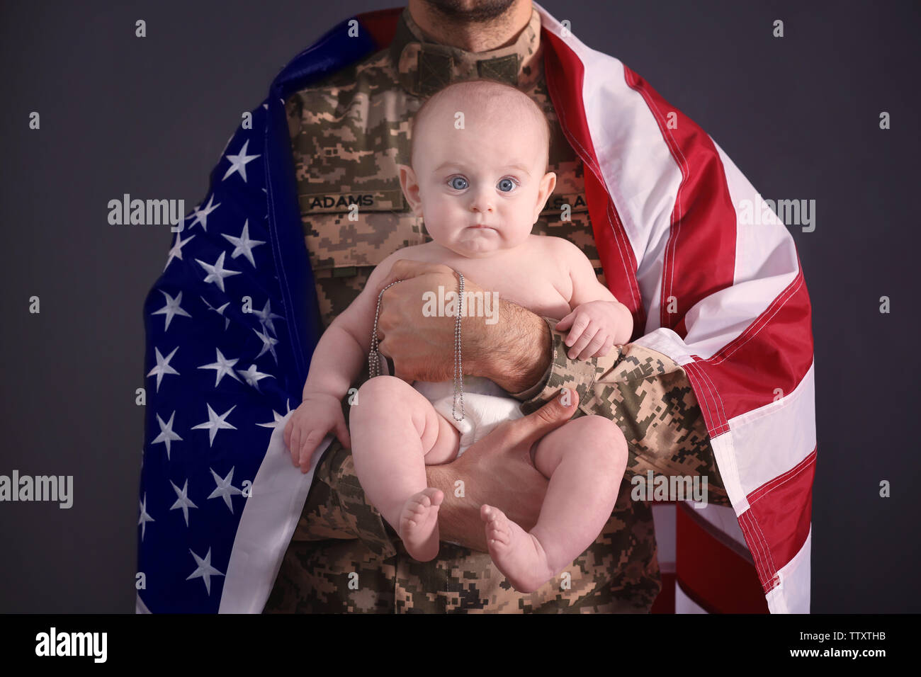 Military father holding his newborn baby Stock Photo - Alamy