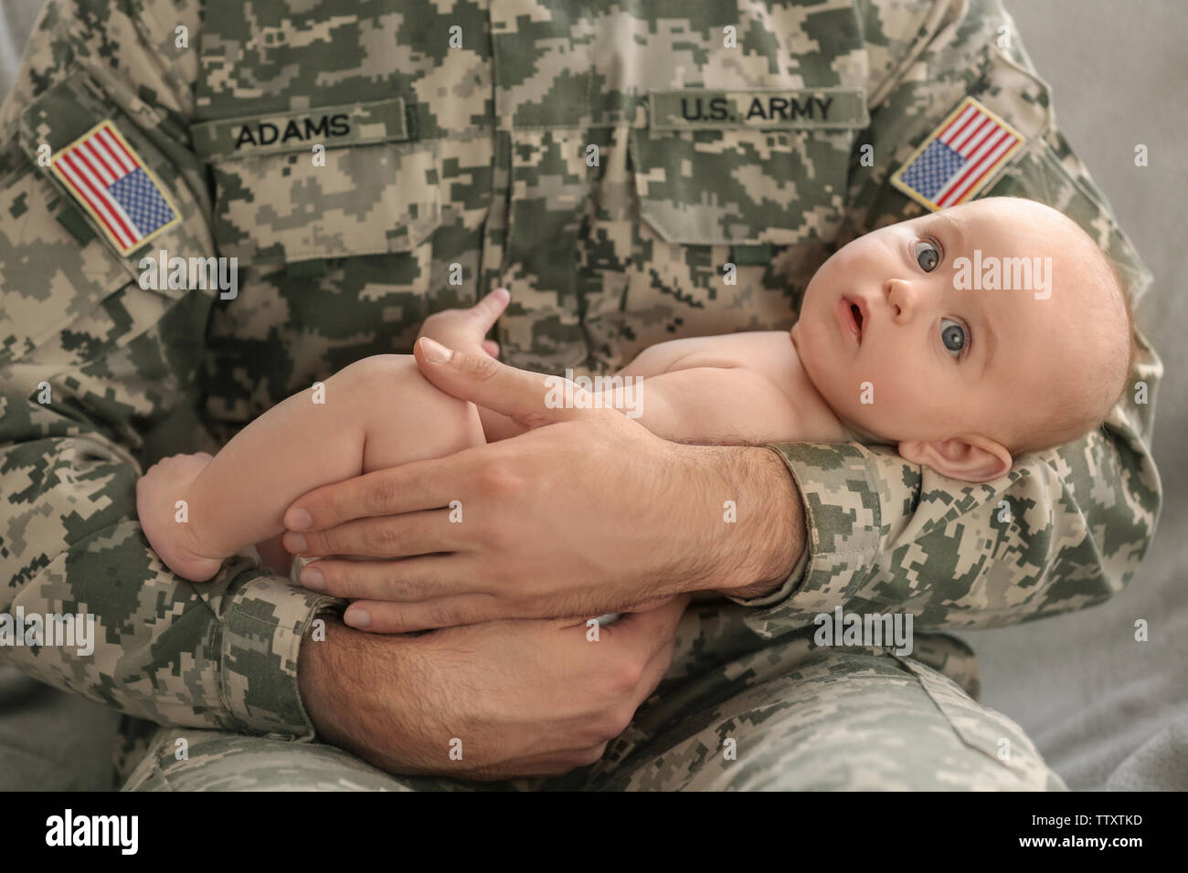 Military father holding his newborn baby Stock Photo - Alamy