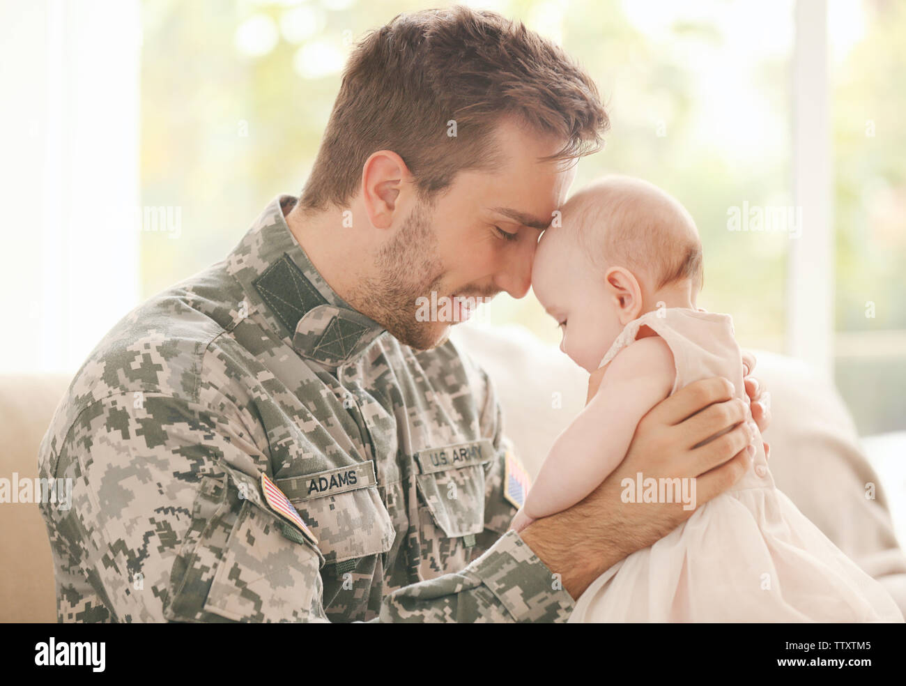 Military father holding his newborn baby Stock Photo - Alamy