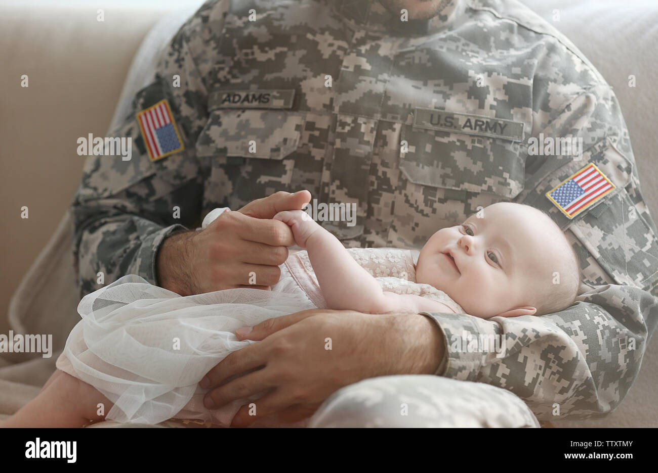 Military father holding his newborn baby Stock Photo - Alamy