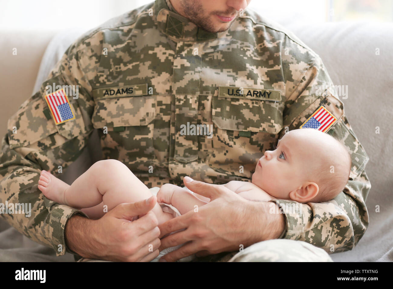 Military father holding his newborn baby Stock Photo - Alamy