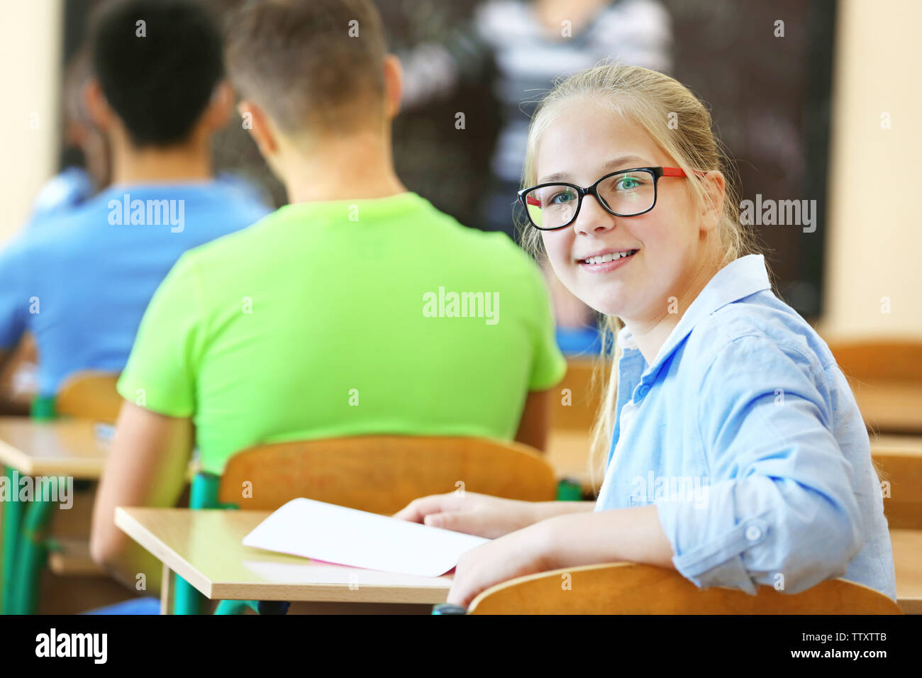 Student with group of classmates in classroom Stock Photo - Alamy