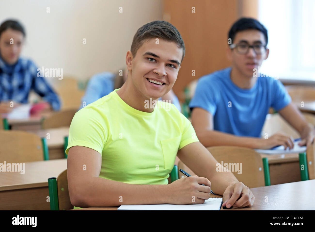 Student with group of classmates in classroom Stock Photo - Alamy