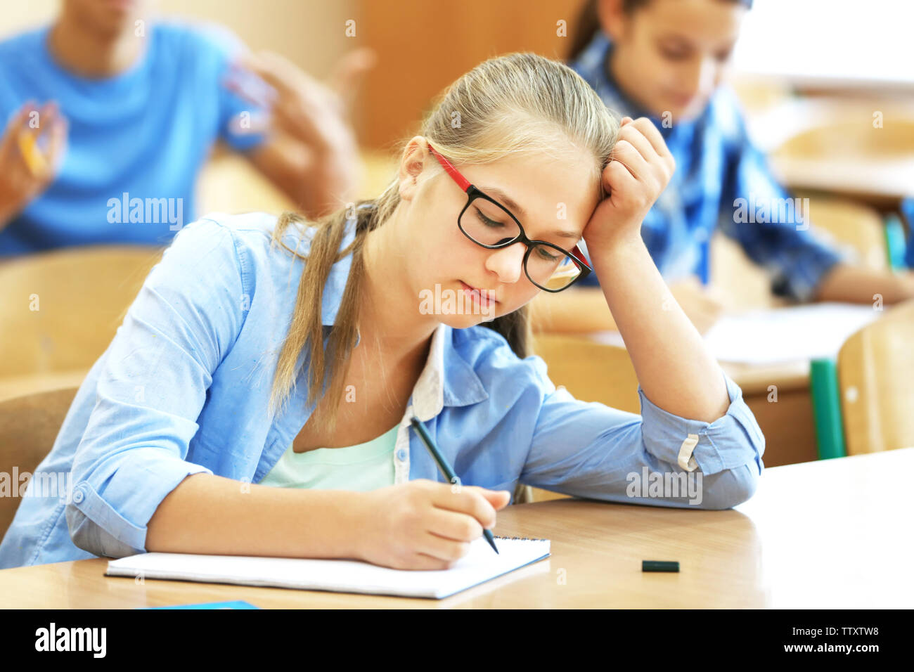 Student with group of classmates in classroom Stock Photo - Alamy