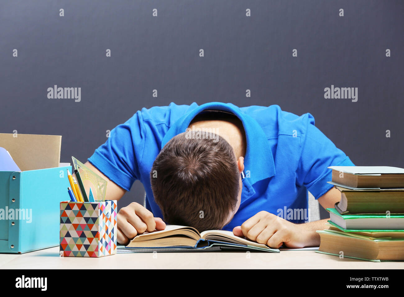 Student tired of studying in classroom Stock Photo - Alamy