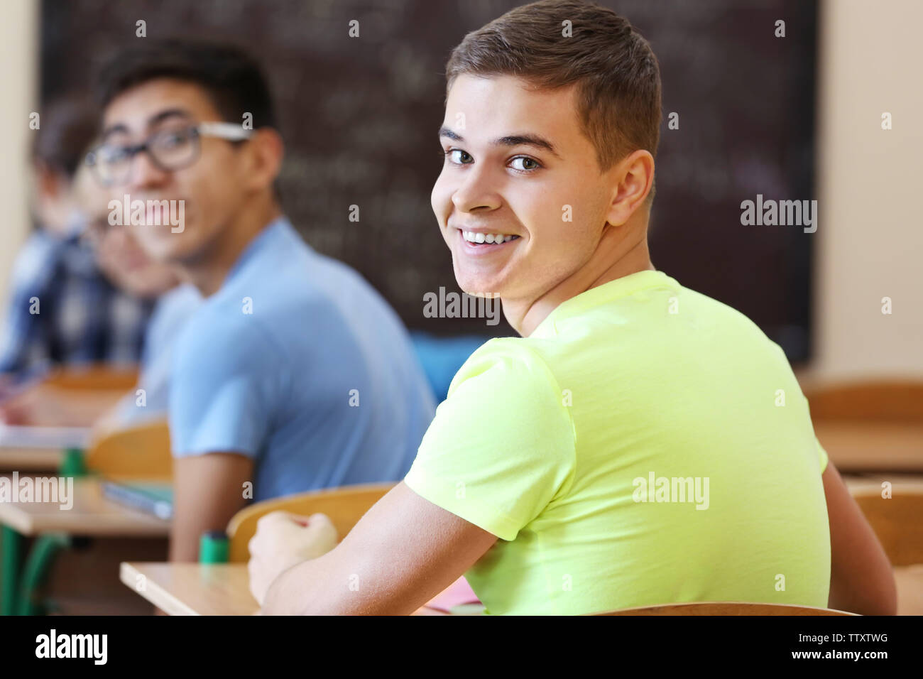 Student with group of classmates in classroom Stock Photo - Alamy