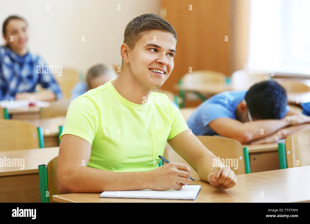 Student with group of classmates in classroom Stock Photo - Alamy