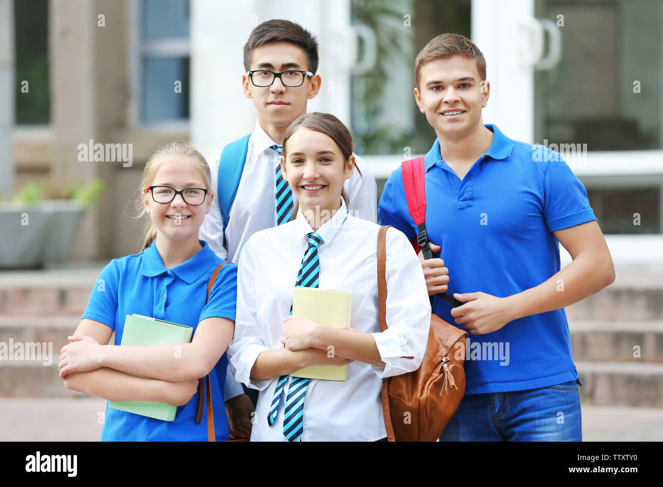 Group of classmates outside the school Stock Photo - Alamy