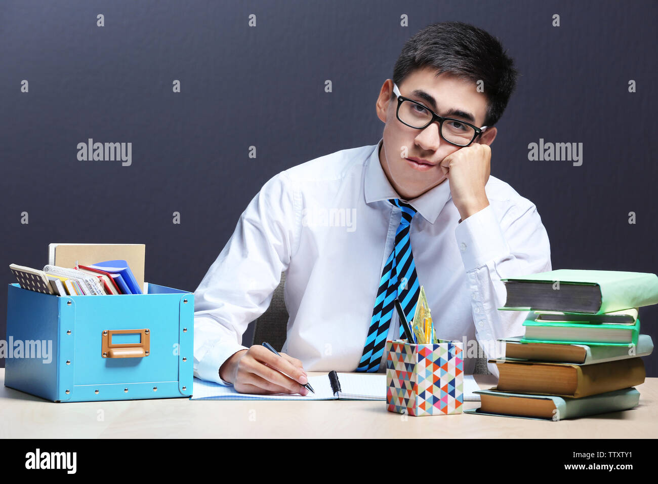 Student tired of studying in classroom Stock Photo - Alamy