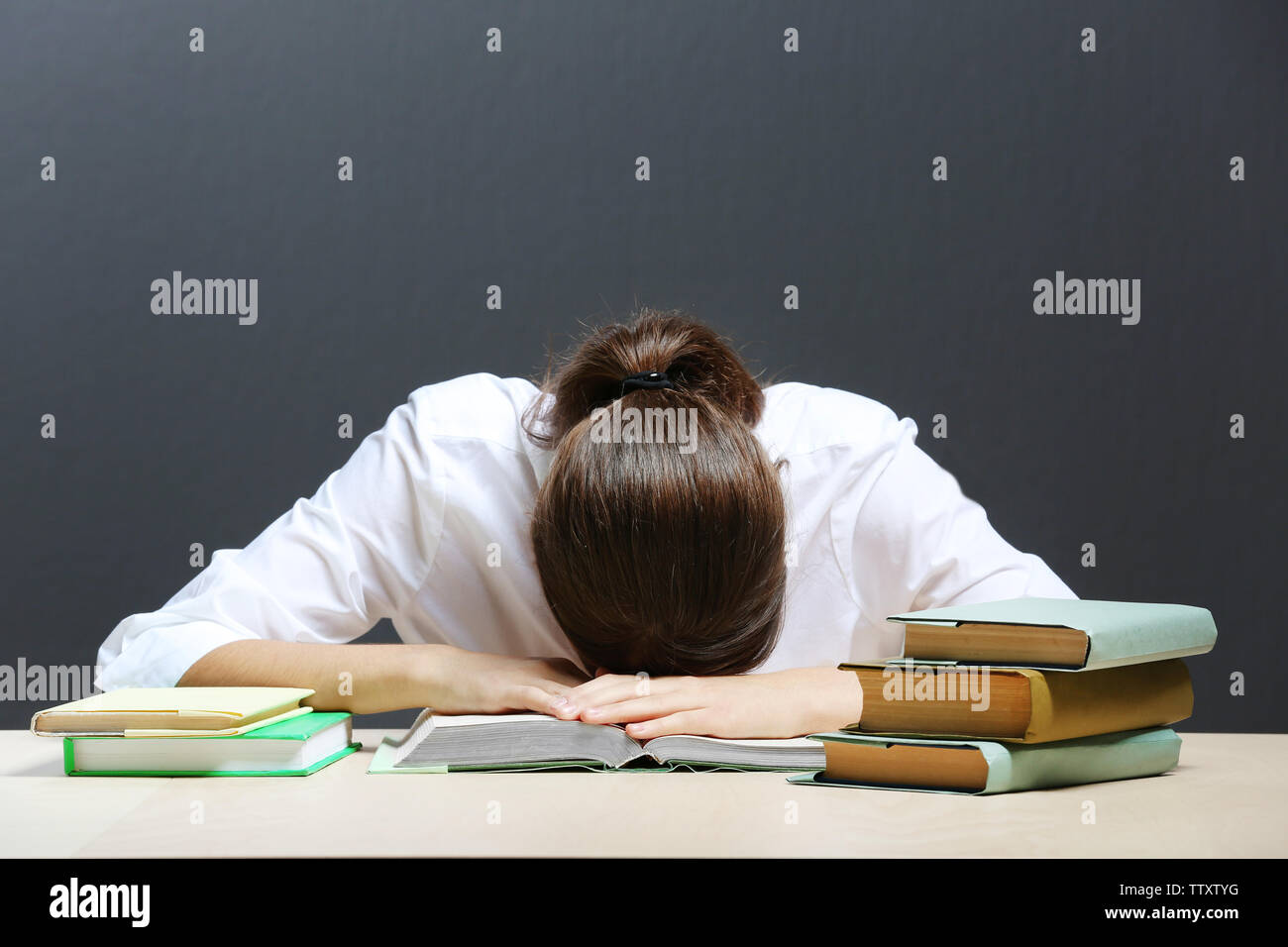 Student tired of studying in classroom Stock Photo - Alamy
