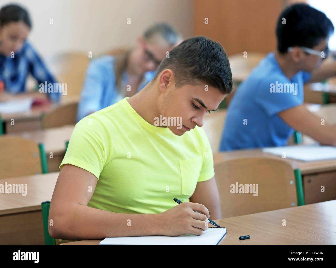 Student with group of classmates in classroom Stock Photo - Alamy