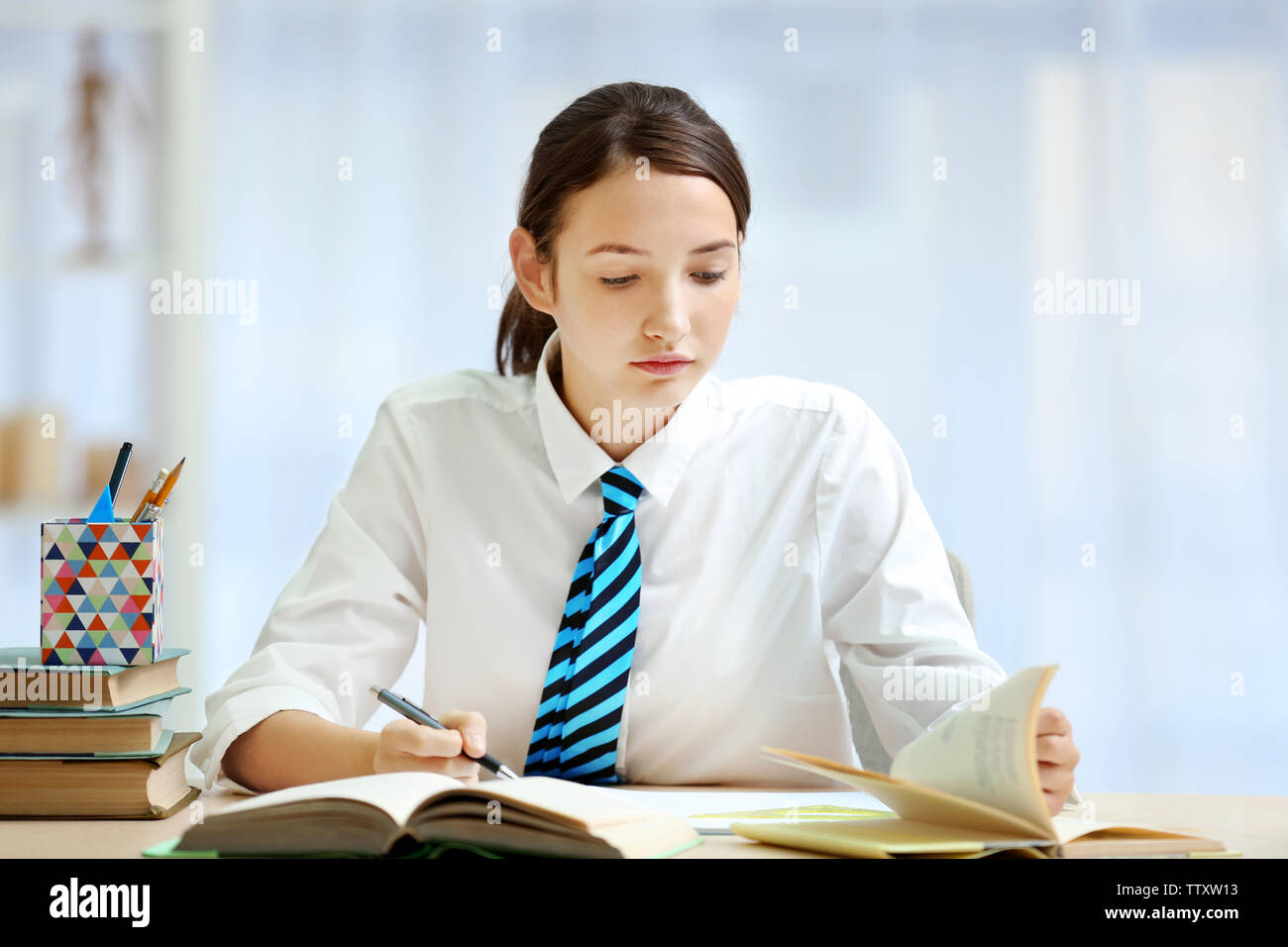Student studying in classroom Stock Photo - Alamy