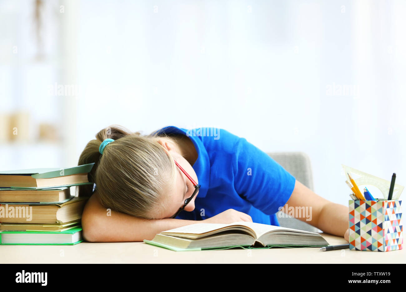 Student tired of studying in classroom Stock Photo - Alamy