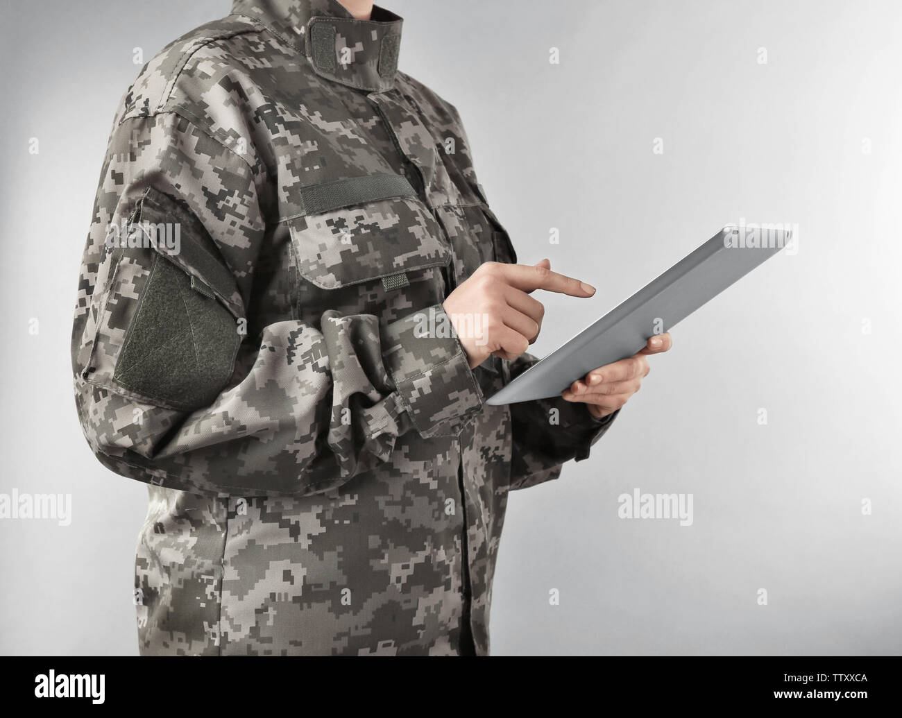 Soldier holding tablet. Military education concept Stock Photo - Alamy