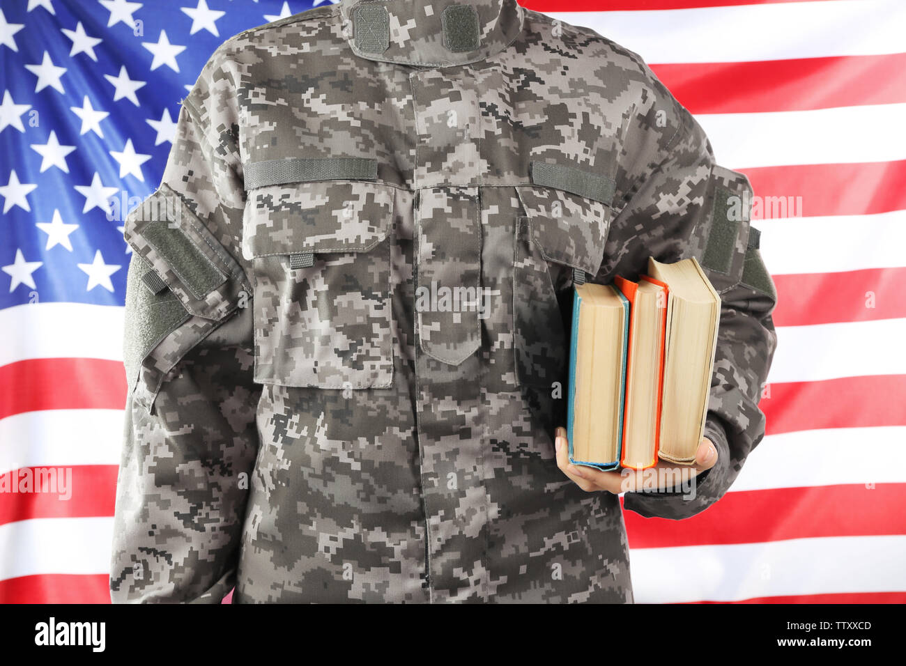 Soldier holding books. Military education concept Stock Photo - Alamy