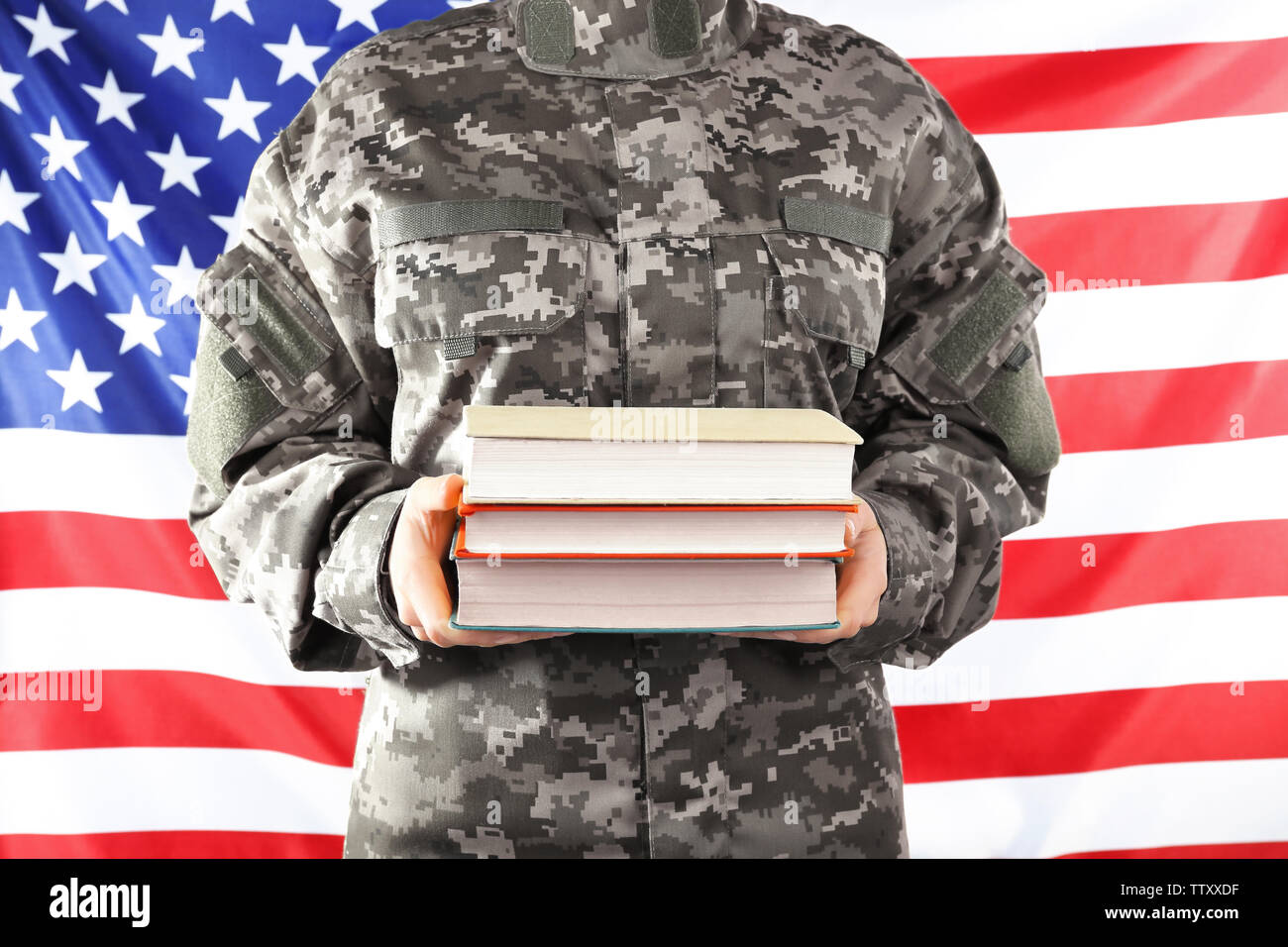 Soldier holding books. Military education concept Stock Photo - Alamy