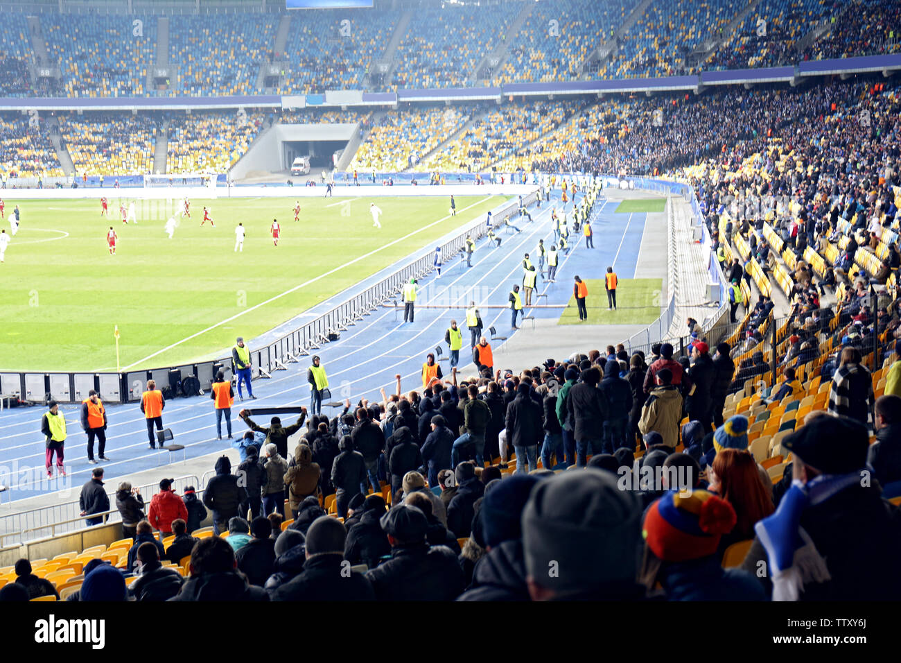 Fans watching football game at stadium Stock Photo - Alamy