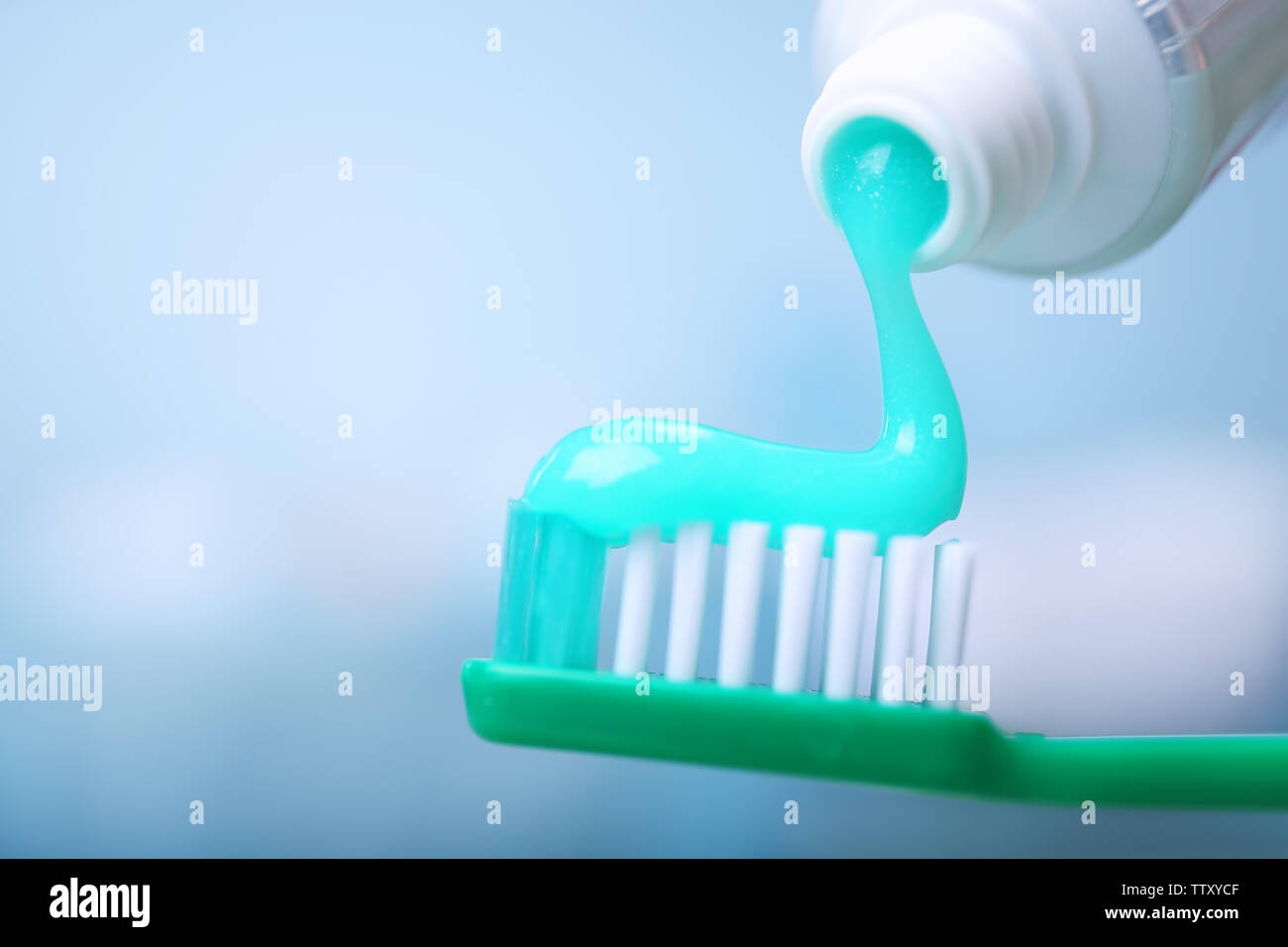 Toothpaste squeezed from tube onto brush, close up Stock Photo - Alamy