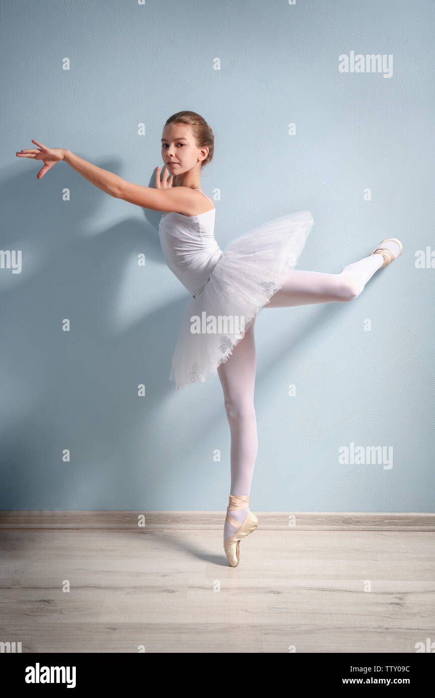 Young beautiful ballerina on wall background Stock Photo - Alamy