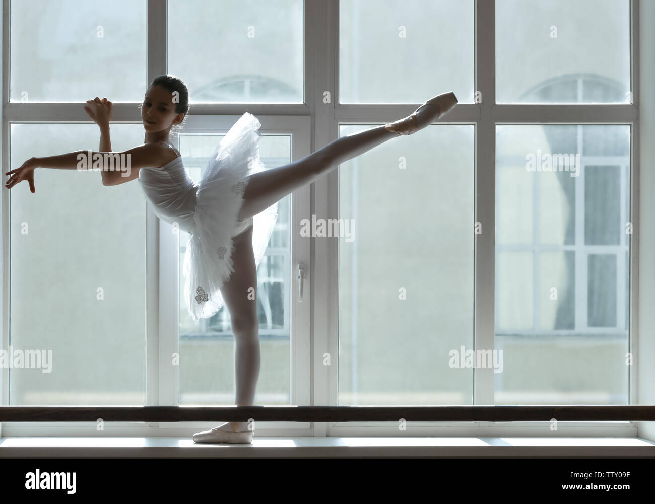 Young beautiful ballerina dancing on windowsill Stock Photo - Alamy