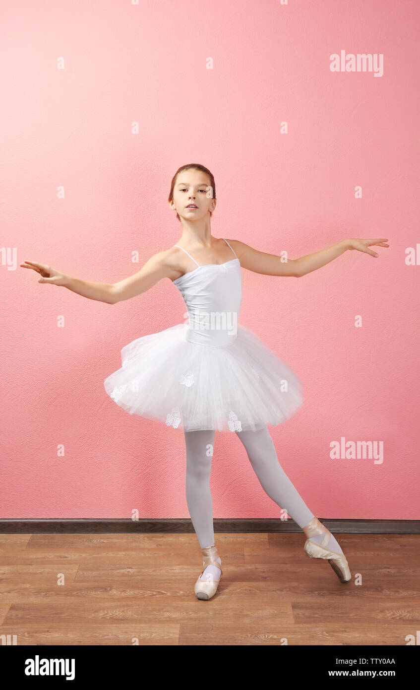 Young beautiful ballerina on wall background Stock Photo - Alamy