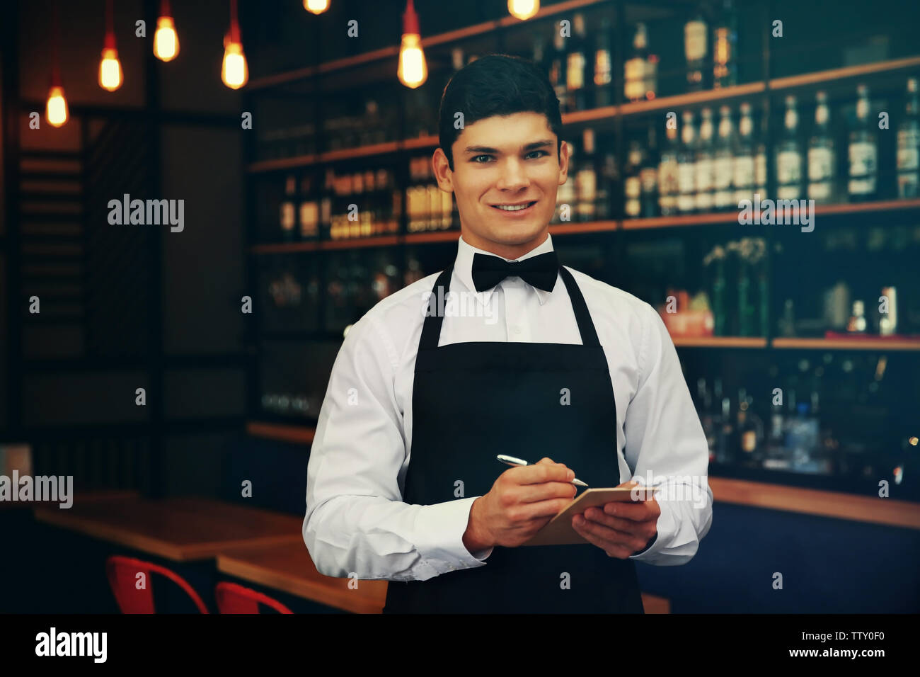 Handsome male waiter in cafe Stock Photo - Alamy