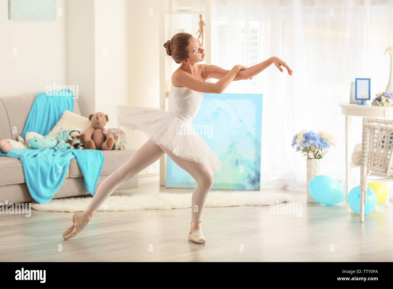 Young beautiful ballerina dancing in room Stock Photo - Alamy