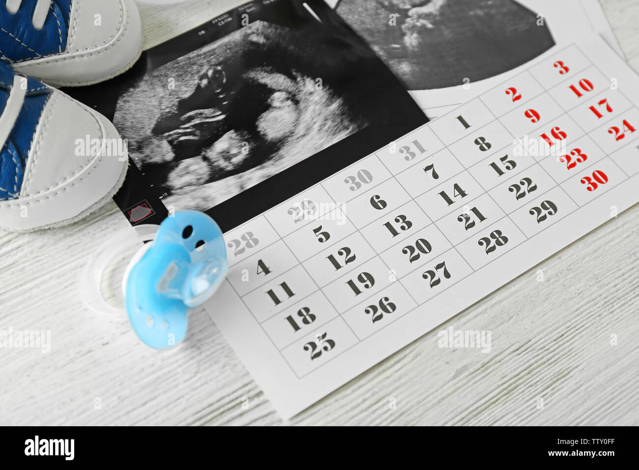 Baby waiting concept. Ultrasound photo and calendar on white wooden ...