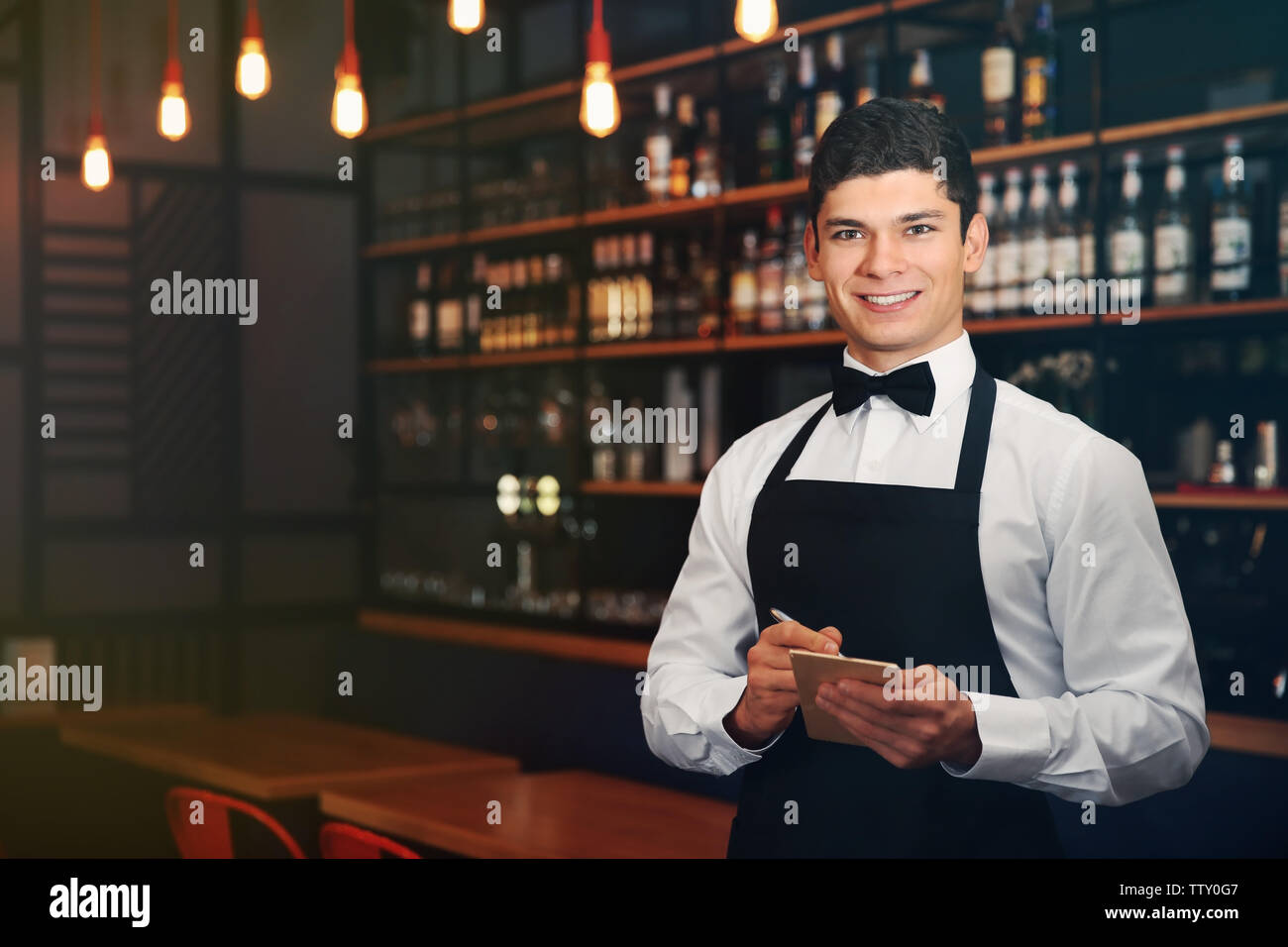 Handsome male waiter in cafe Stock Photo - Alamy