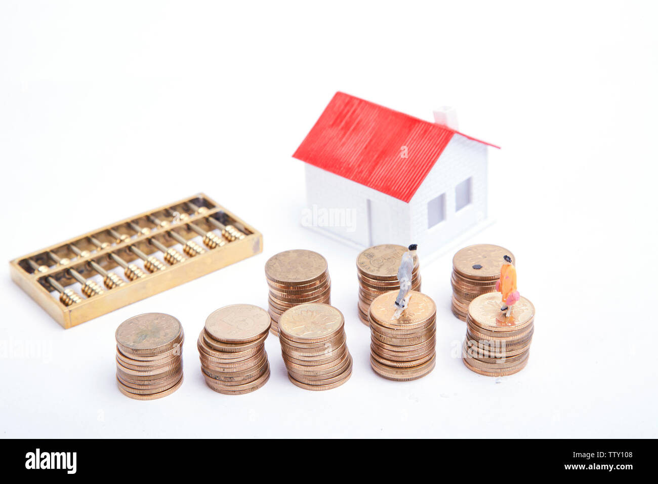Coin house model and couple on white background Stock Photo - Alamy