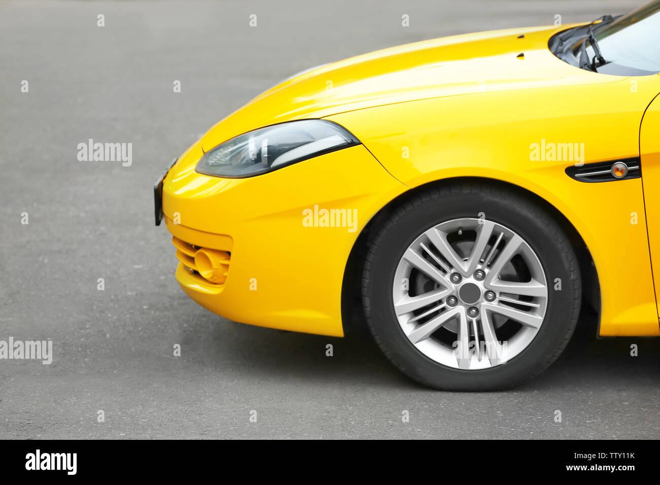 Modern yellow car on road Stock Photo - Alamy