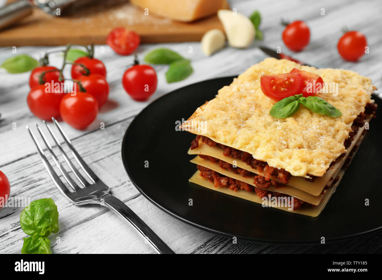 Homemade meat lasagna on white wooden table Stock Photo - Alamy