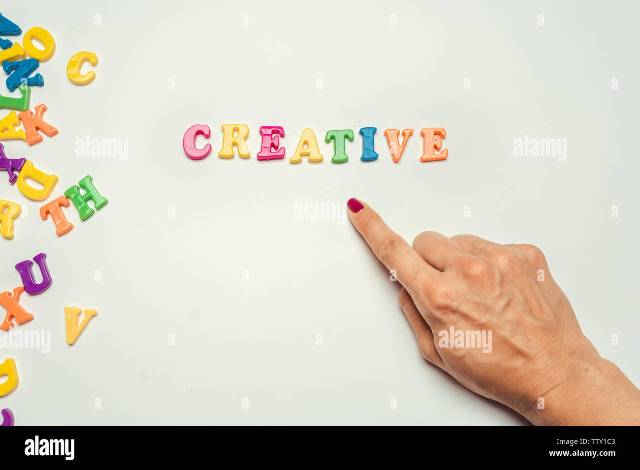 Creative concept, word in colorful plastic letters on white background ...