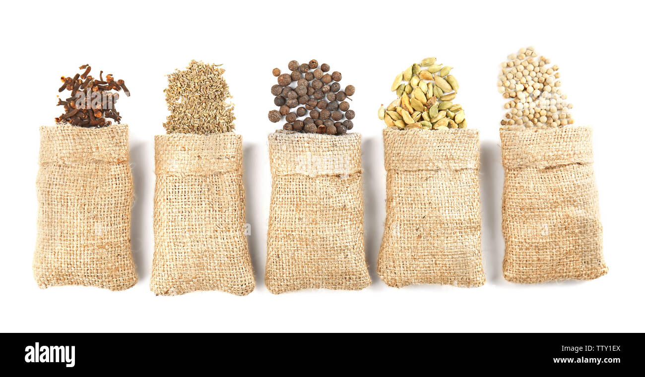 Spices in sacking bags on white background, top view Stock Photo - Alamy