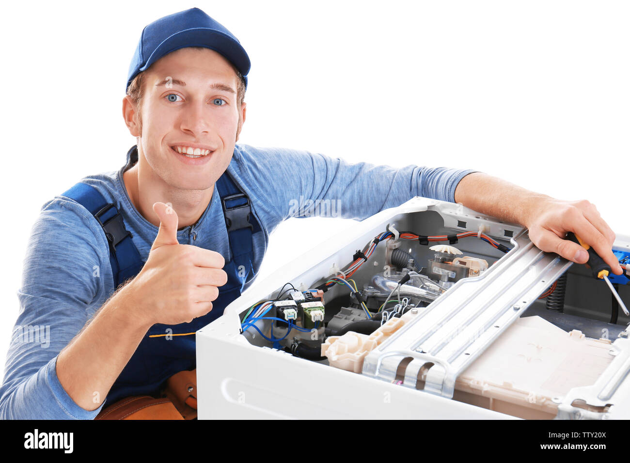 Plumber with washing machine on white background Stock Photo - Alamy