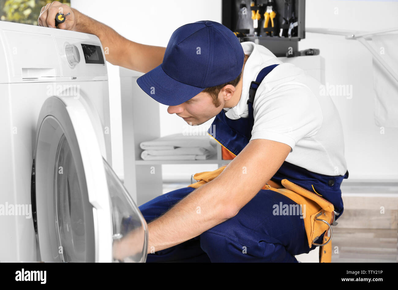 Repairing washing machine hi-res stock photography and images - Alamy