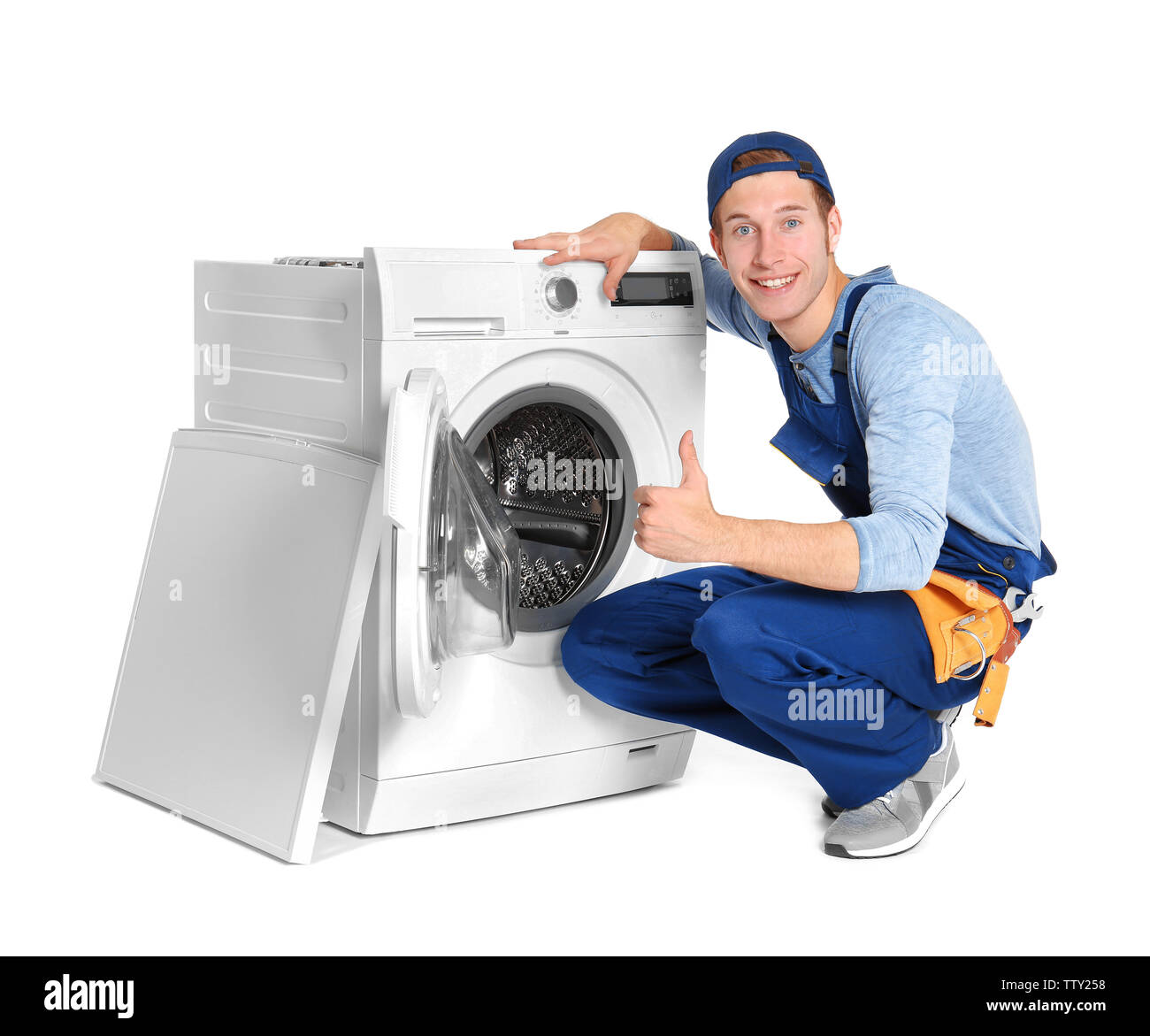 Plumber with washing machine on white background Stock Photo - Alamy