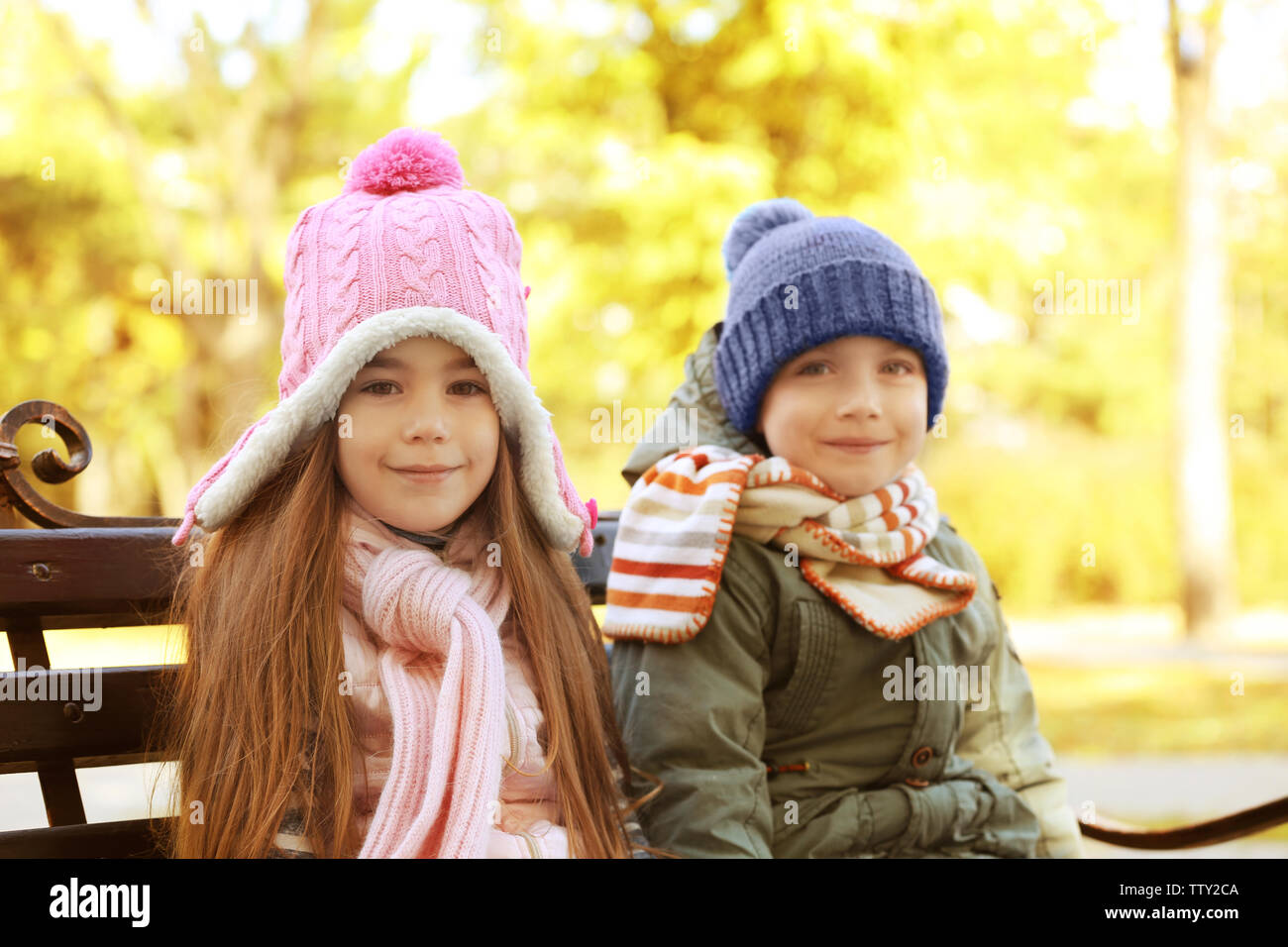 Children sitting on bench in hi-res stock photography and images - Alamy