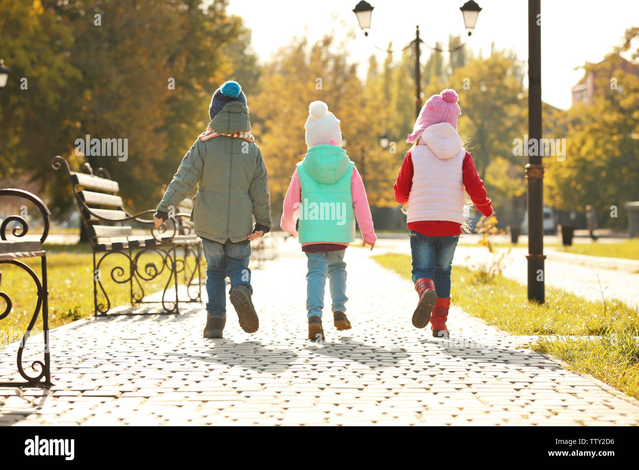 Group of children having fun walking in park Stock Photo - Alamy