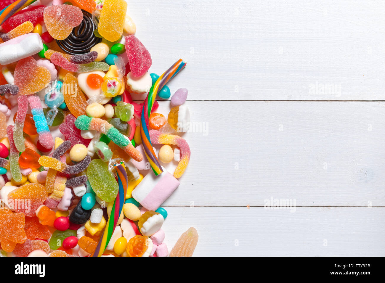 Colorful candies on wooden background Stock Photo - Alamy