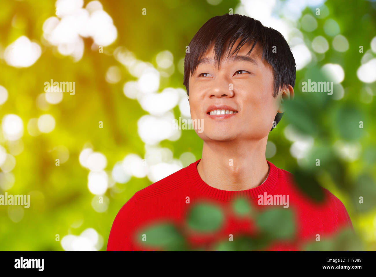 Handsome young asian man smiling Stock Photo - Alamy