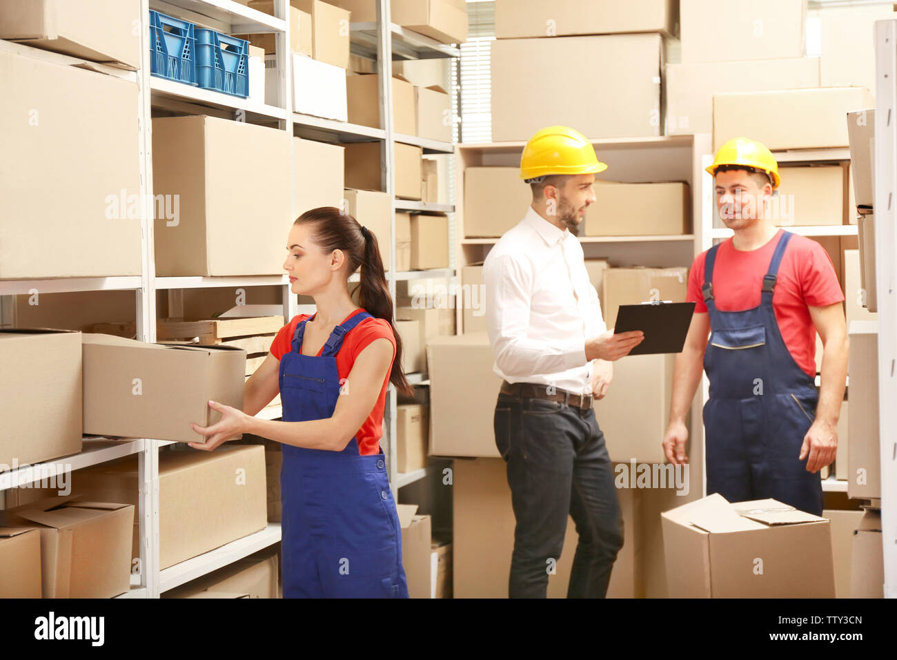 Business people working at warehouse Stock Photo - Alamy