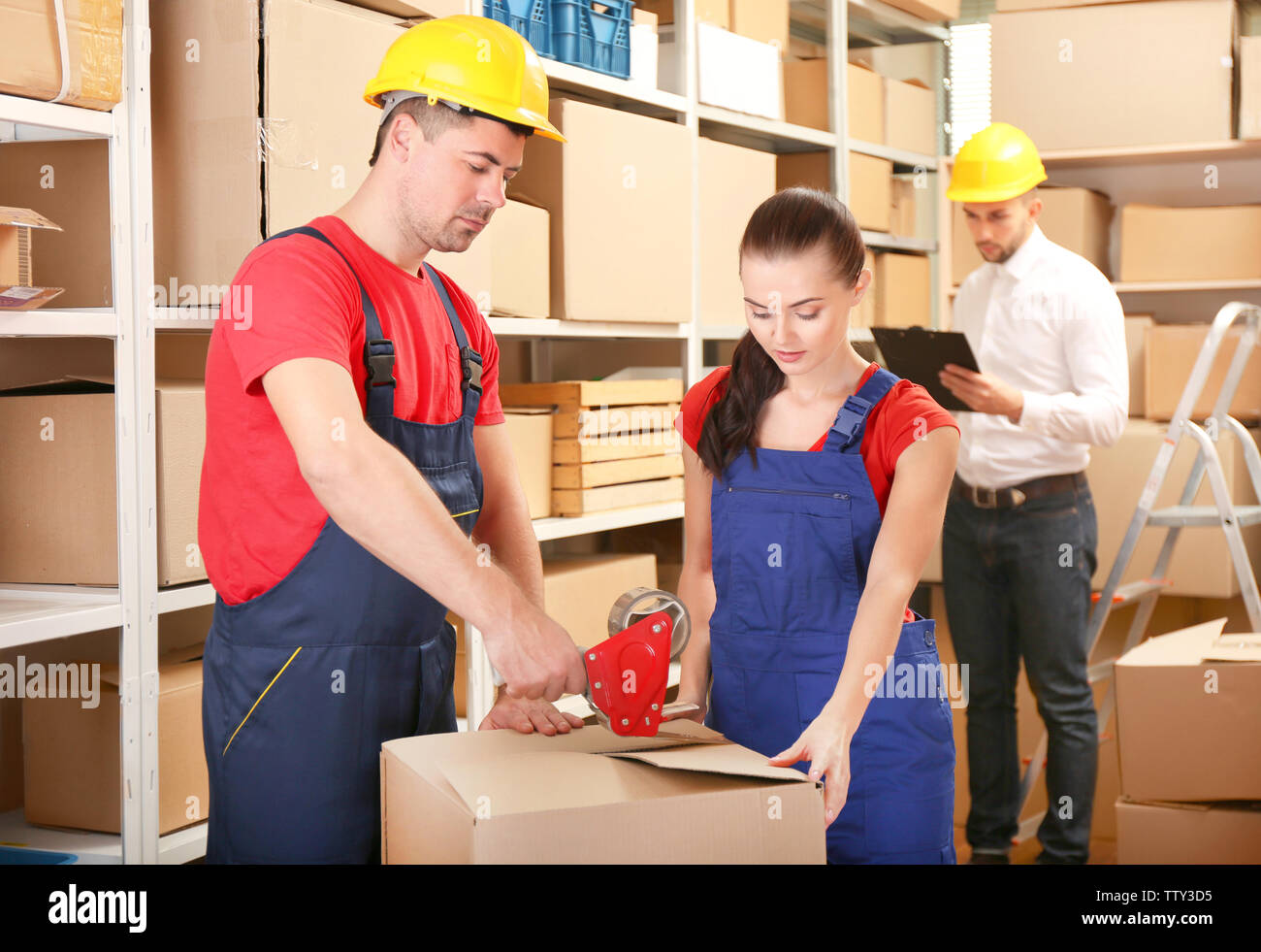 Business people working at warehouse Stock Photo - Alamy