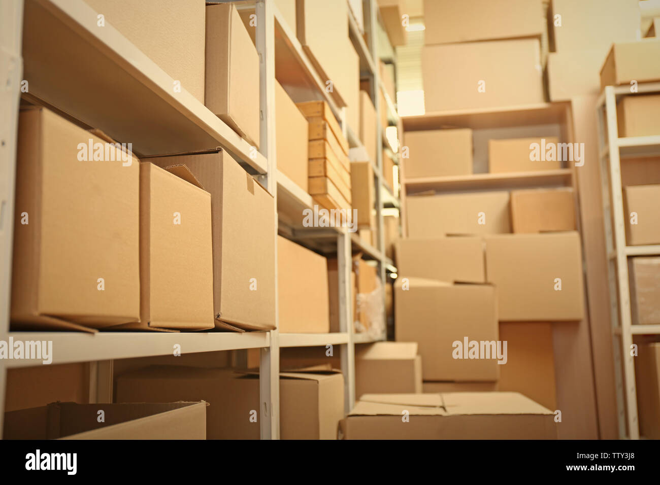 Modern warehouse full of cardboard boxes Stock Photo - Alamy