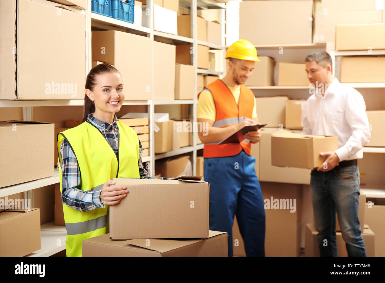 Business people working at warehouse Stock Photo - Alamy