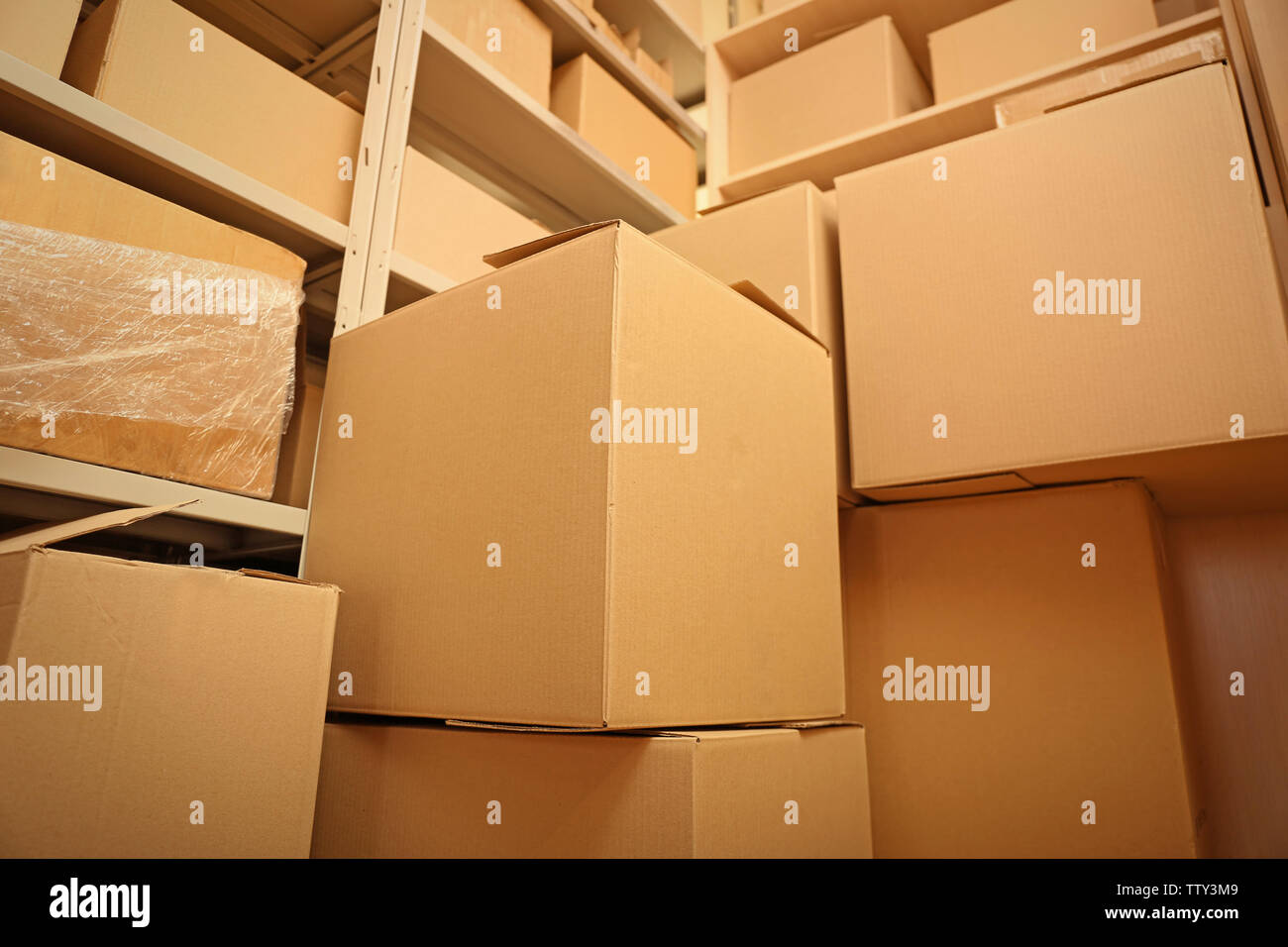 Modern warehouse full of cardboard boxes Stock Photo - Alamy