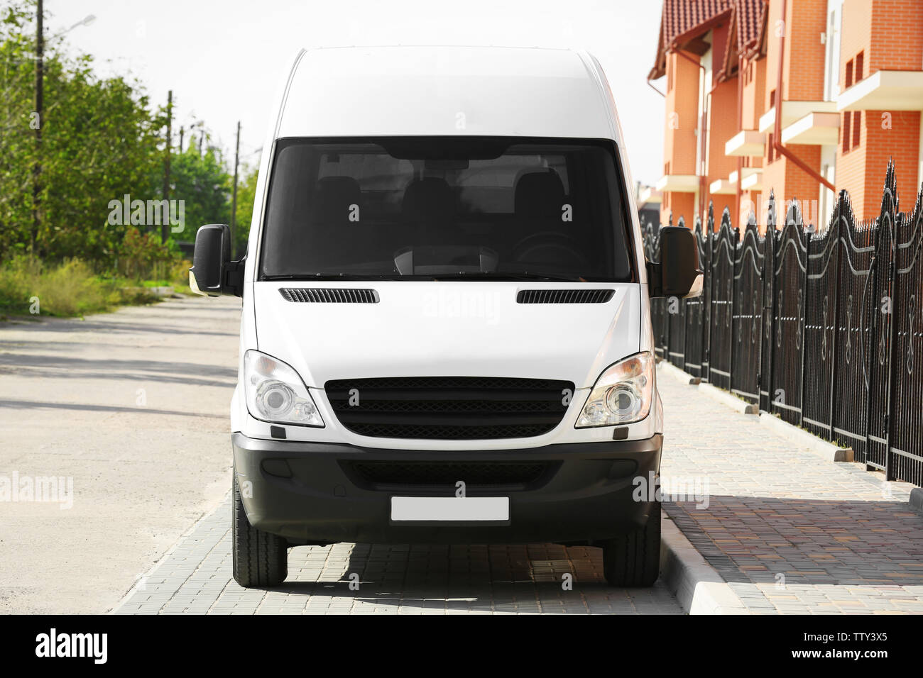 White van parked on street Stock Photo - Alamy