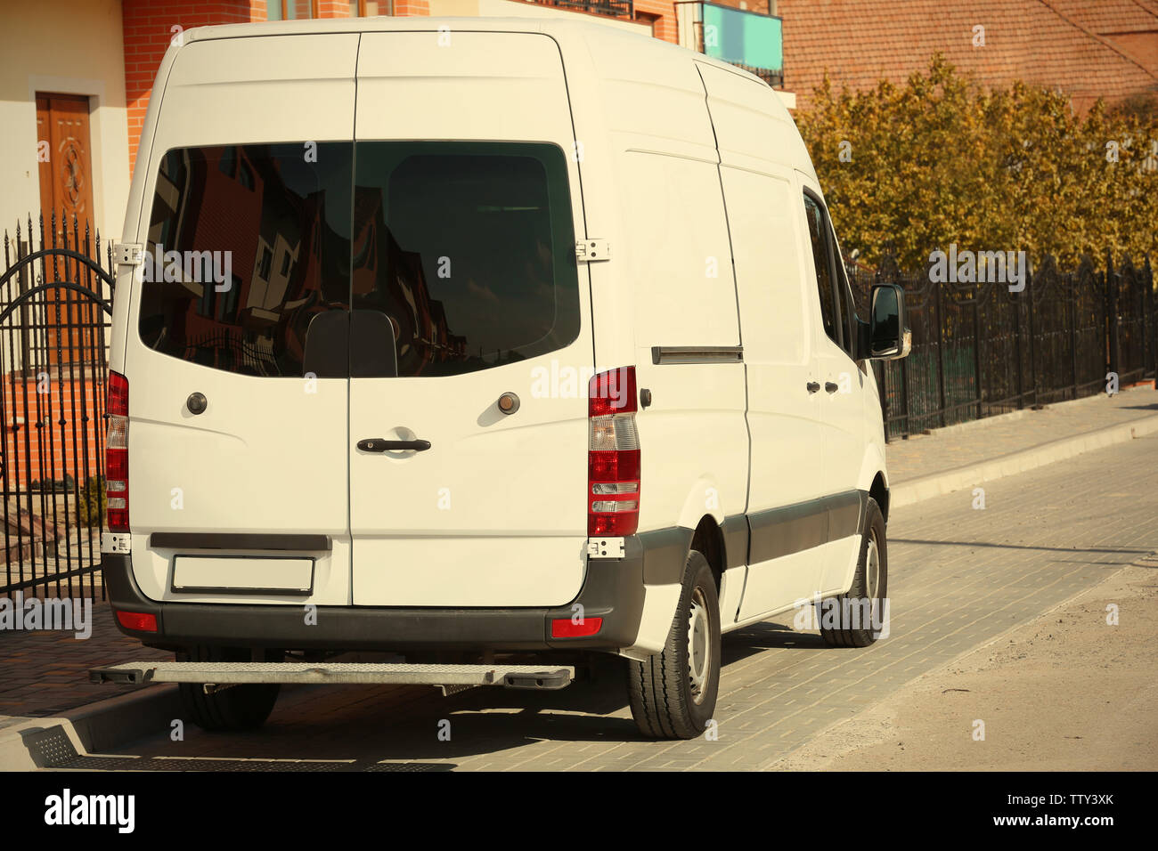 White van parked on street Stock Photo - Alamy
